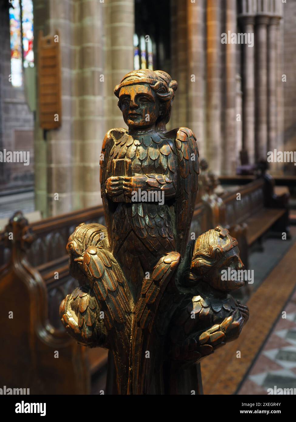 Medieval angel carving on the end of a choir bench in Chester cathedral ...