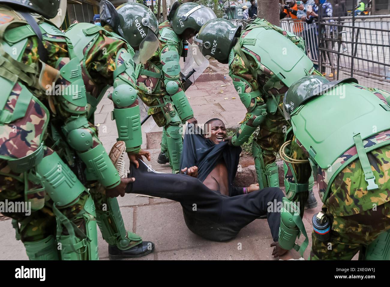 Nairobi, Kenya. 27th June, 2024. Anti-riot police arrest a demonstrator ...