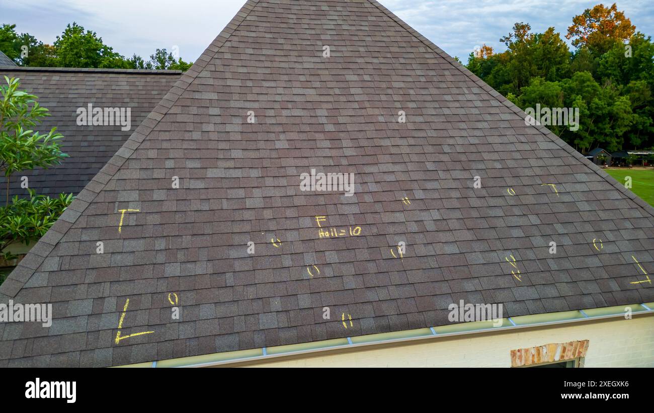 Roof with hail damage and marking from hail insurance inspection Stock ...