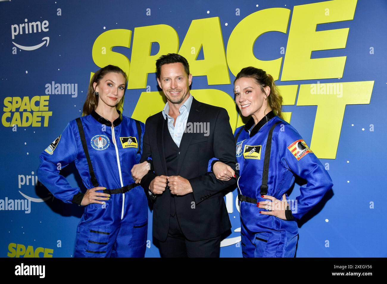 Actor Andrew Call, center, poses with space cadet models at the Amazon ...