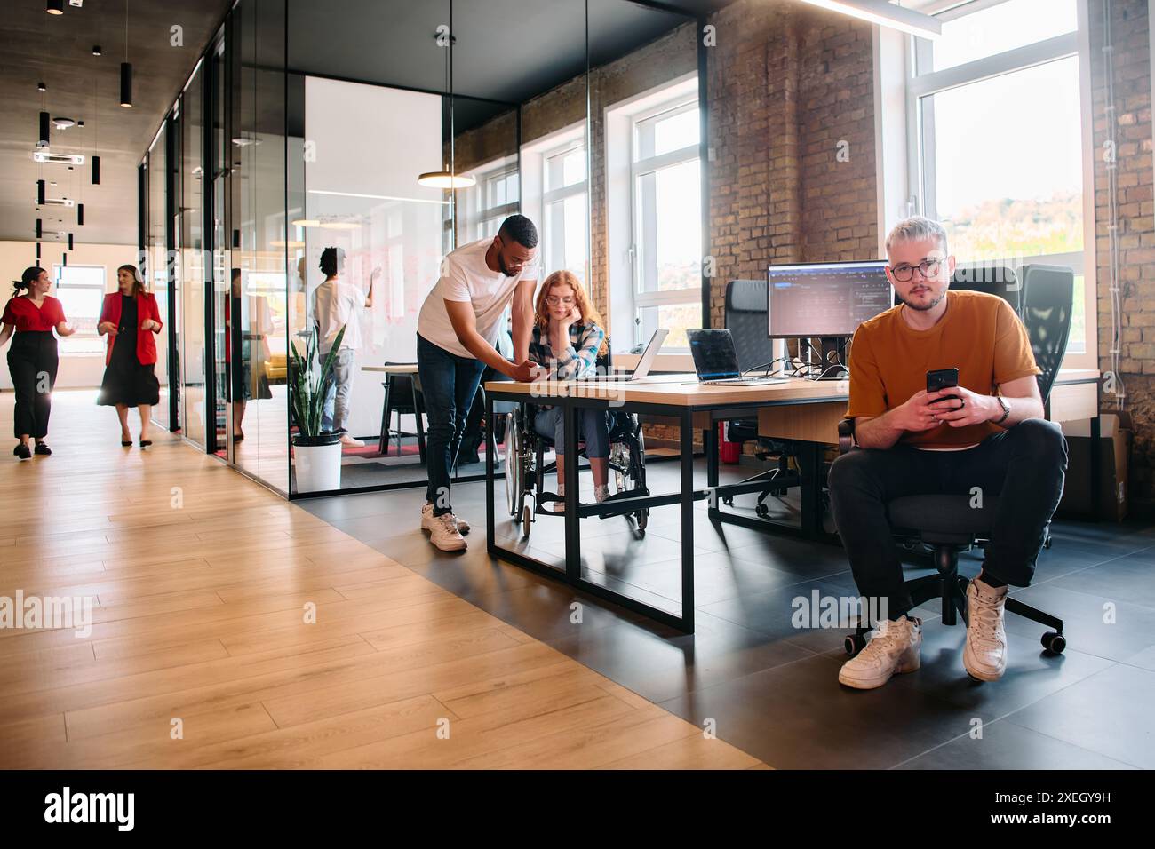 A diverse group of business professionals collaborates in a modern ...