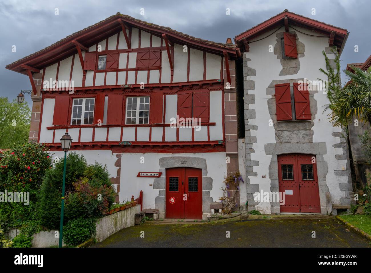 Typical colourful Basque houses in the mountain village of Ainhoa in ...