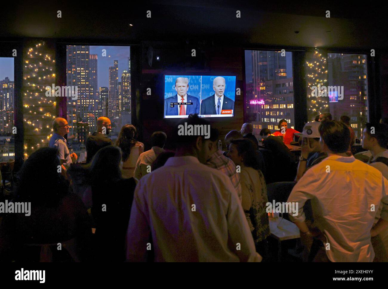 Visitors to a rooftop bar in Times Square watch the CNN presidential ...