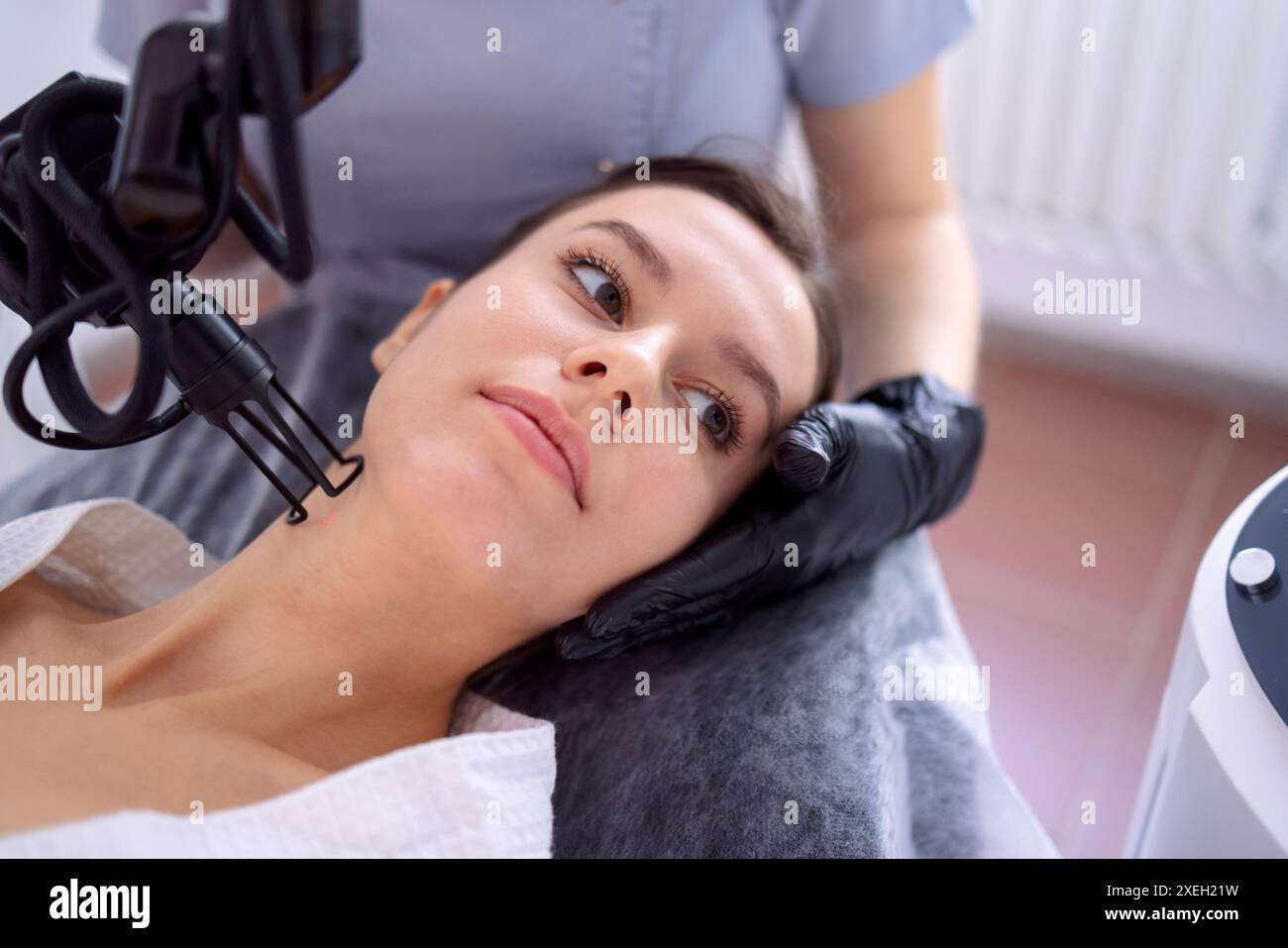 Young woman undergoing laser resurfacing and peeling procedure Stock ...