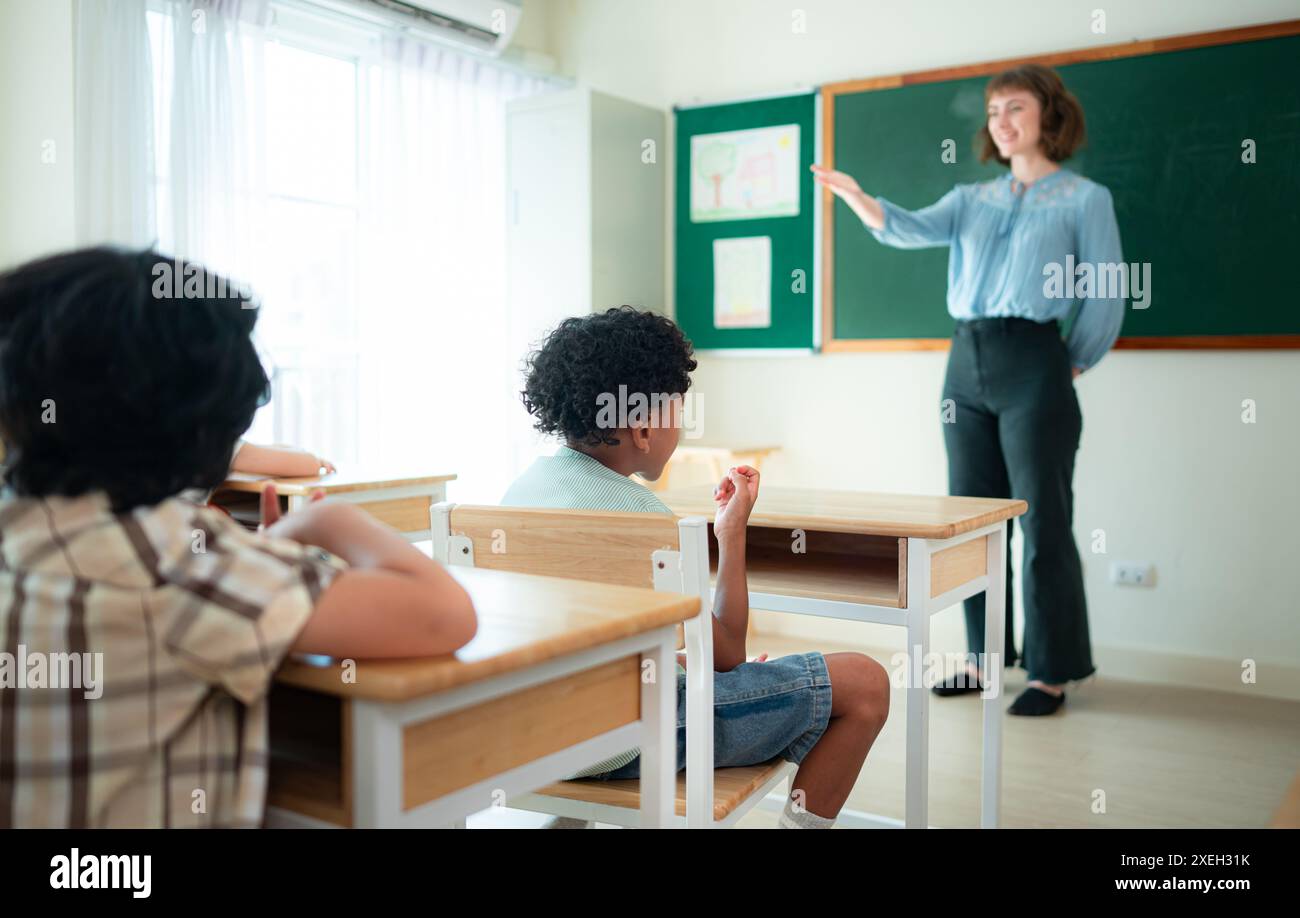 Teacher and students, Learn and study in a classroom of school where ...