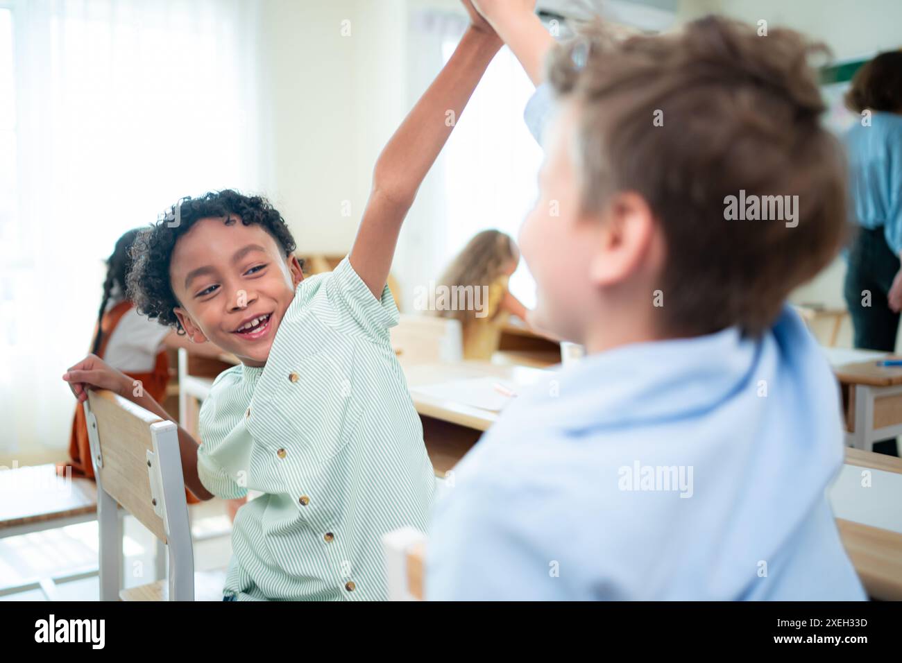 Students learn and study in a classroom of school where youngsters sit ...