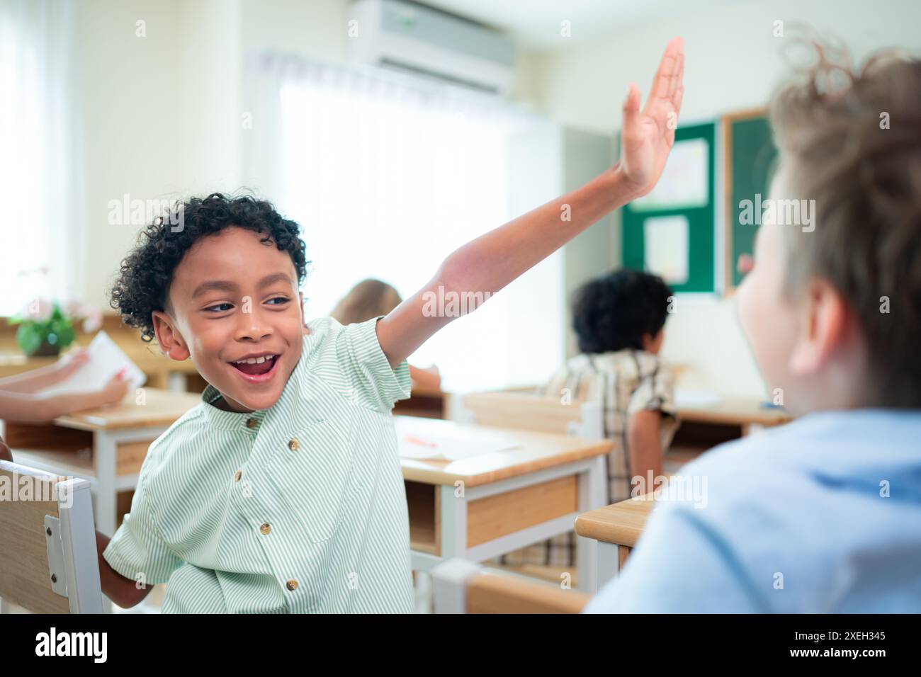 Students learn and study in a classroom of school where youngsters sit ...