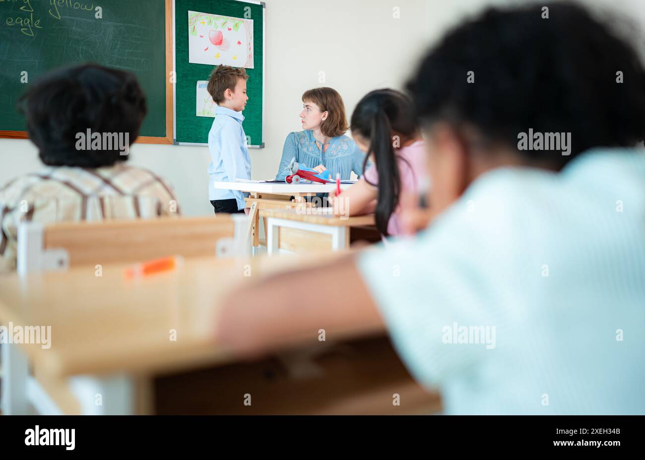 Children with classroom presentation activities in front of the ...