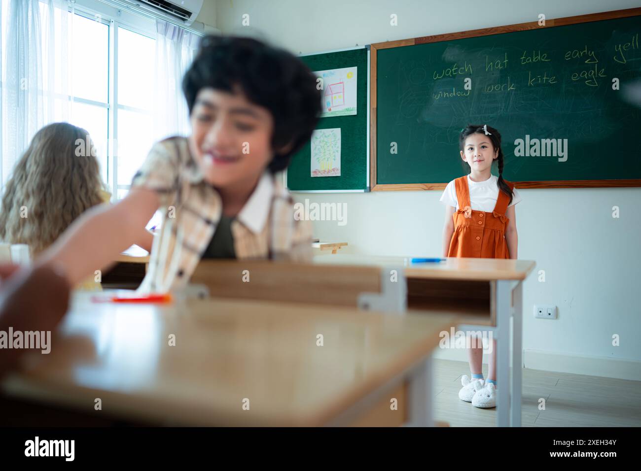 Children with classroom presentation activities in front of the ...