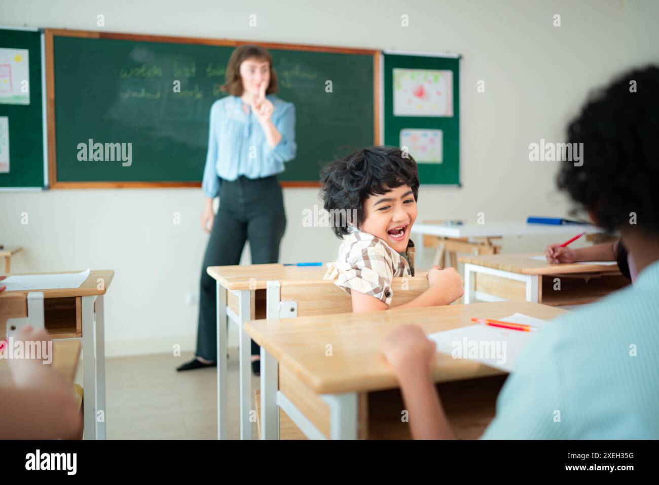 Students learn and study in a classroom of school where youngsters sit ...