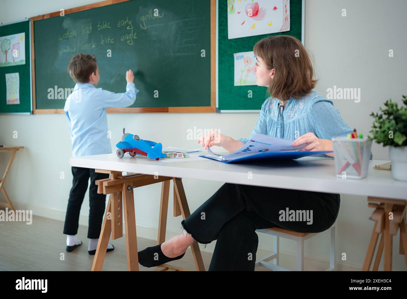 Children with classroom presentation activities in front of the ...