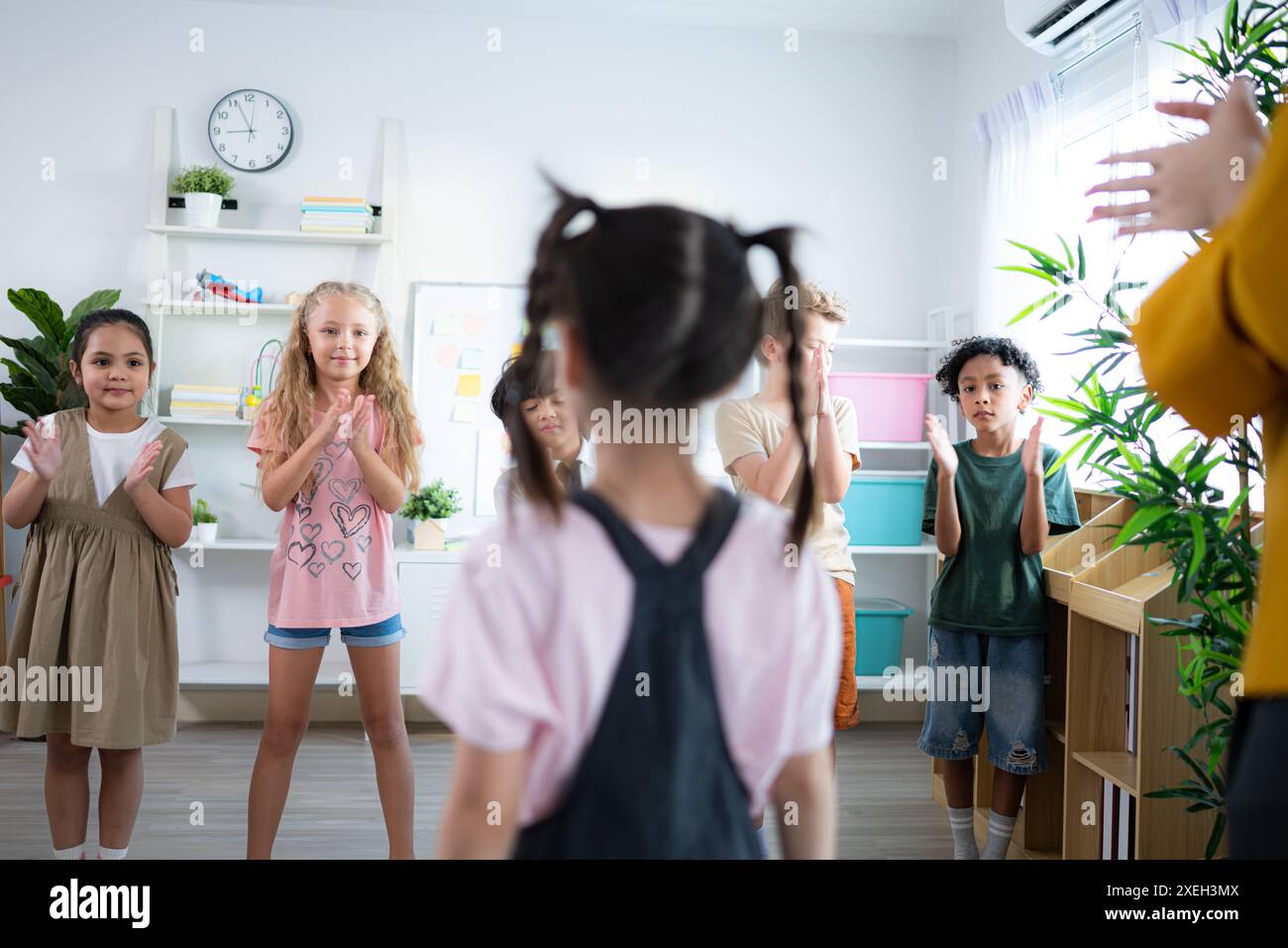 Teacher and students, Standing applause to congratulate one student in ...