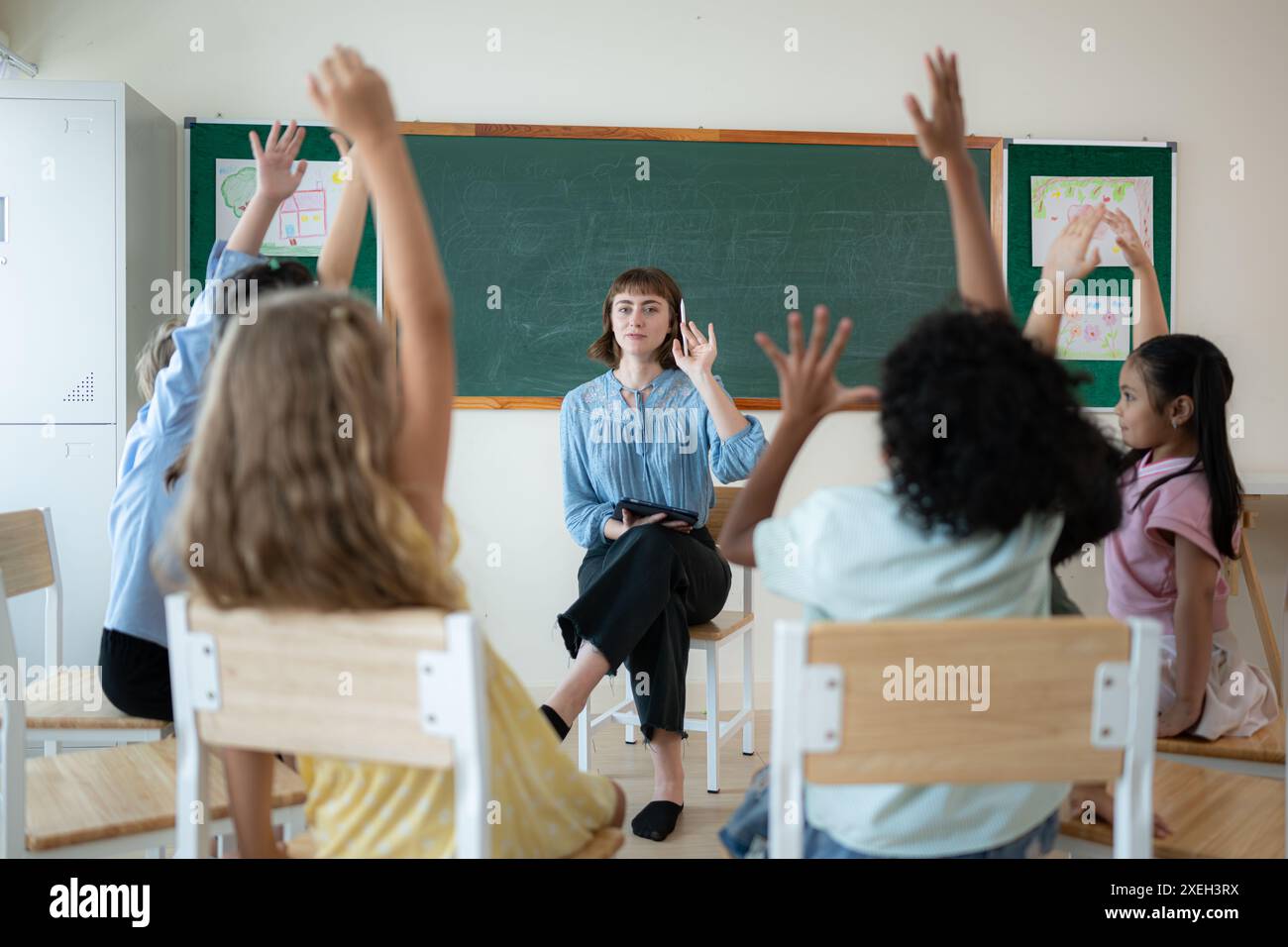 Teacher and students, Learn and study in a classroom of school where ...