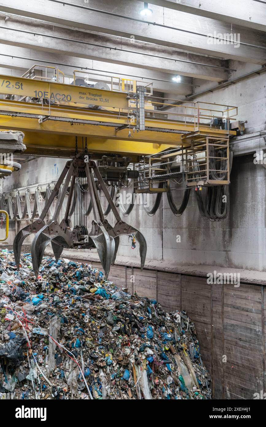 Grab crane picks up the waste for incineration in a waste-to-energy ...