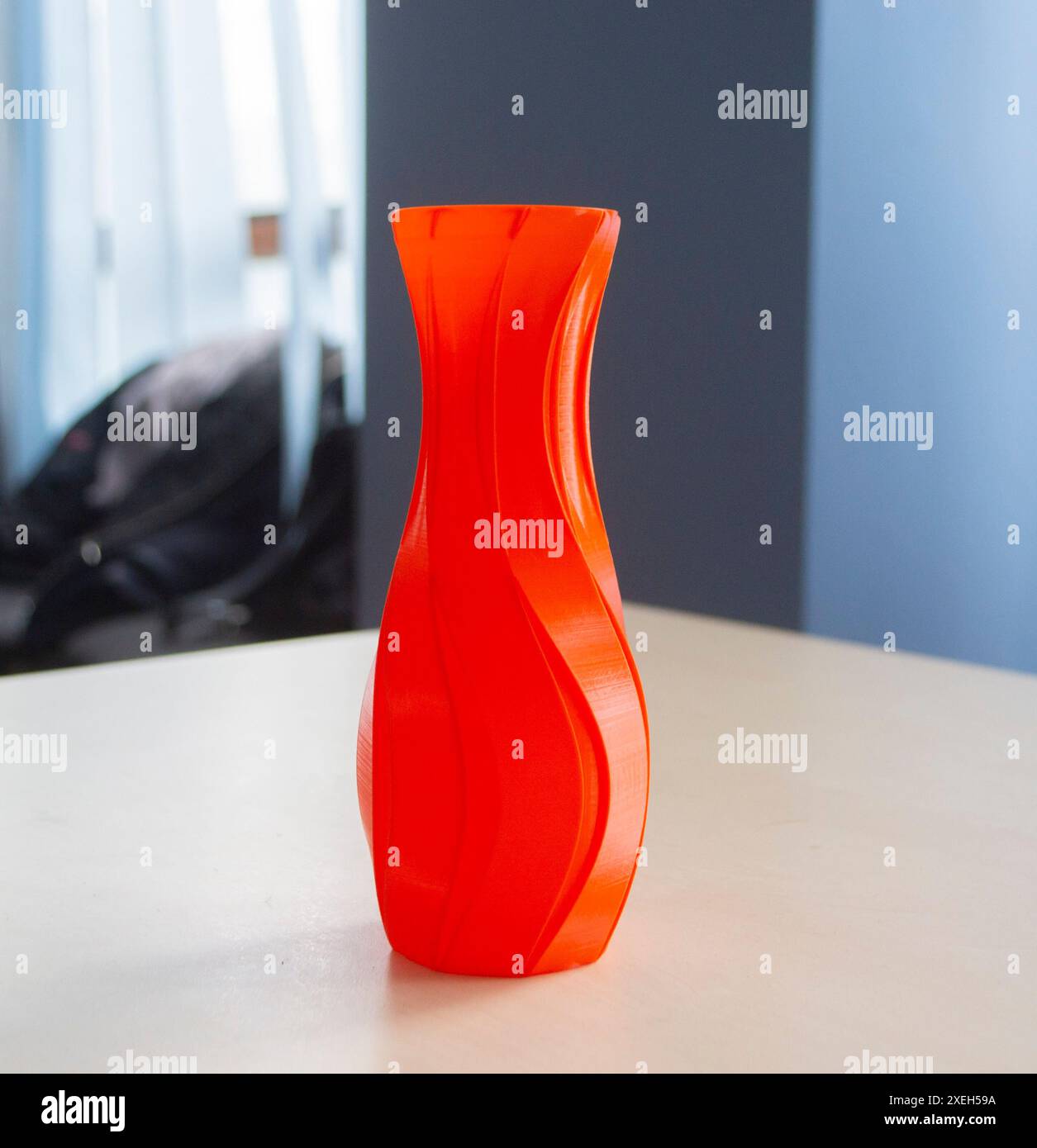 Object in the form of a vase of red color printed on a 3D printer ...