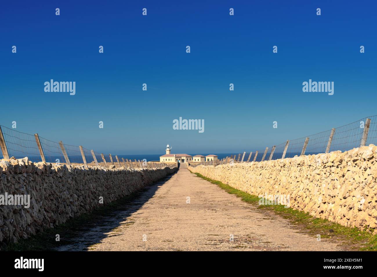 Long gravel road leading to the lighthosue at Punta Nati on Menoorca ...