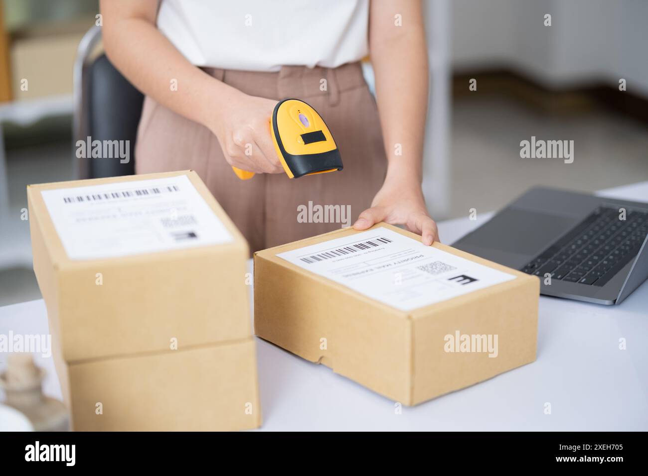 Woman scanning barcode shopping hi-res stock photography and images - Alamy