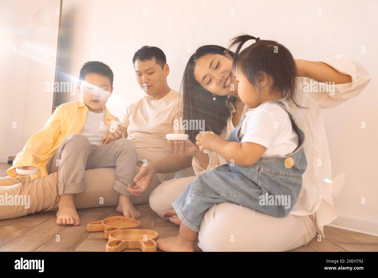 A happy Asian family. Korean parents and their cute little children ...