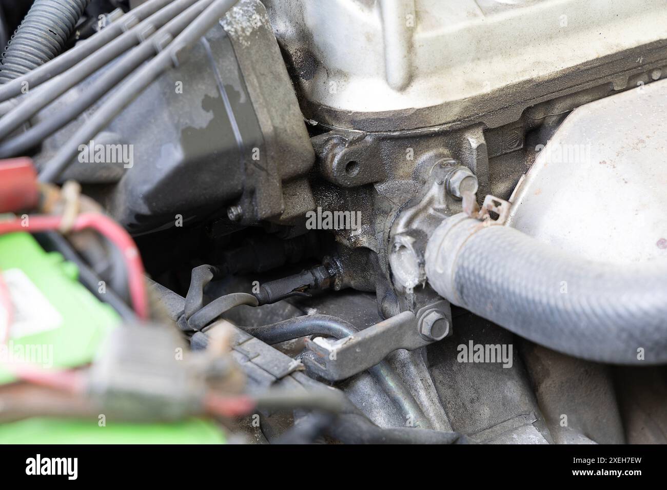 Detailed view of car engine parts including hoses and cables ...