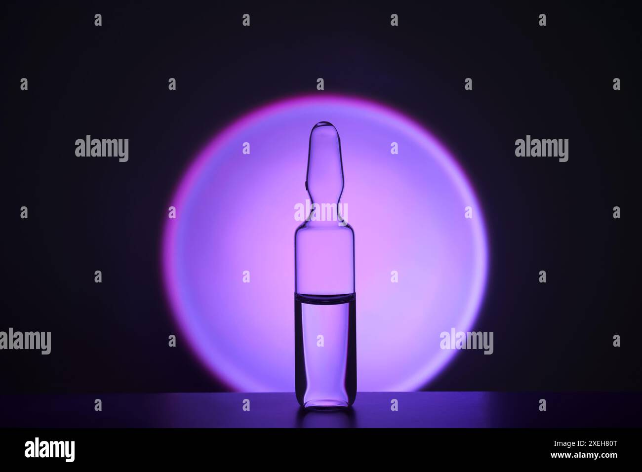 Several ampoules for injection with medicines on a lilac background ...