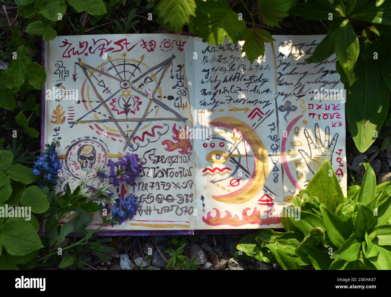 Still life with old open magic book pages with ritual spells outside on ...