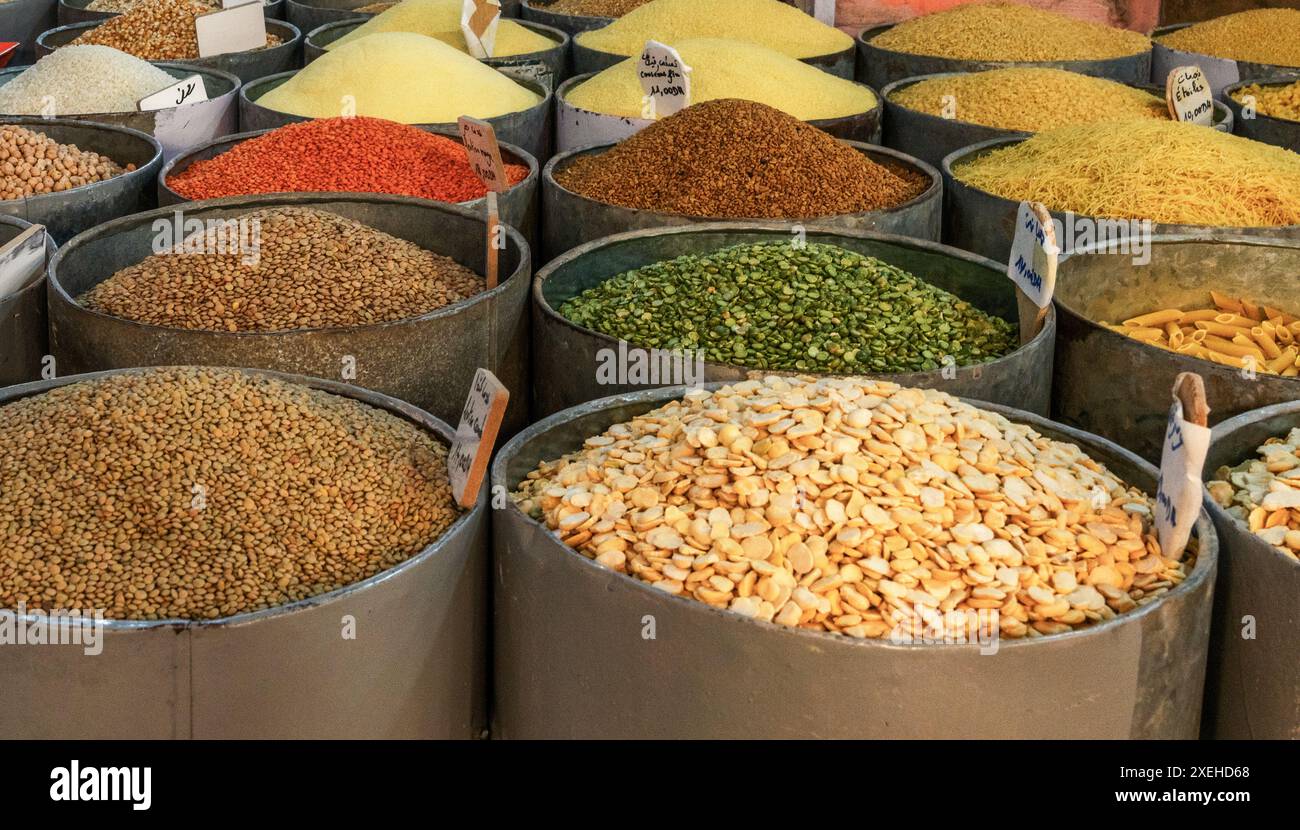 Close-up view of various types of beans and legumes in steel buckets in ...