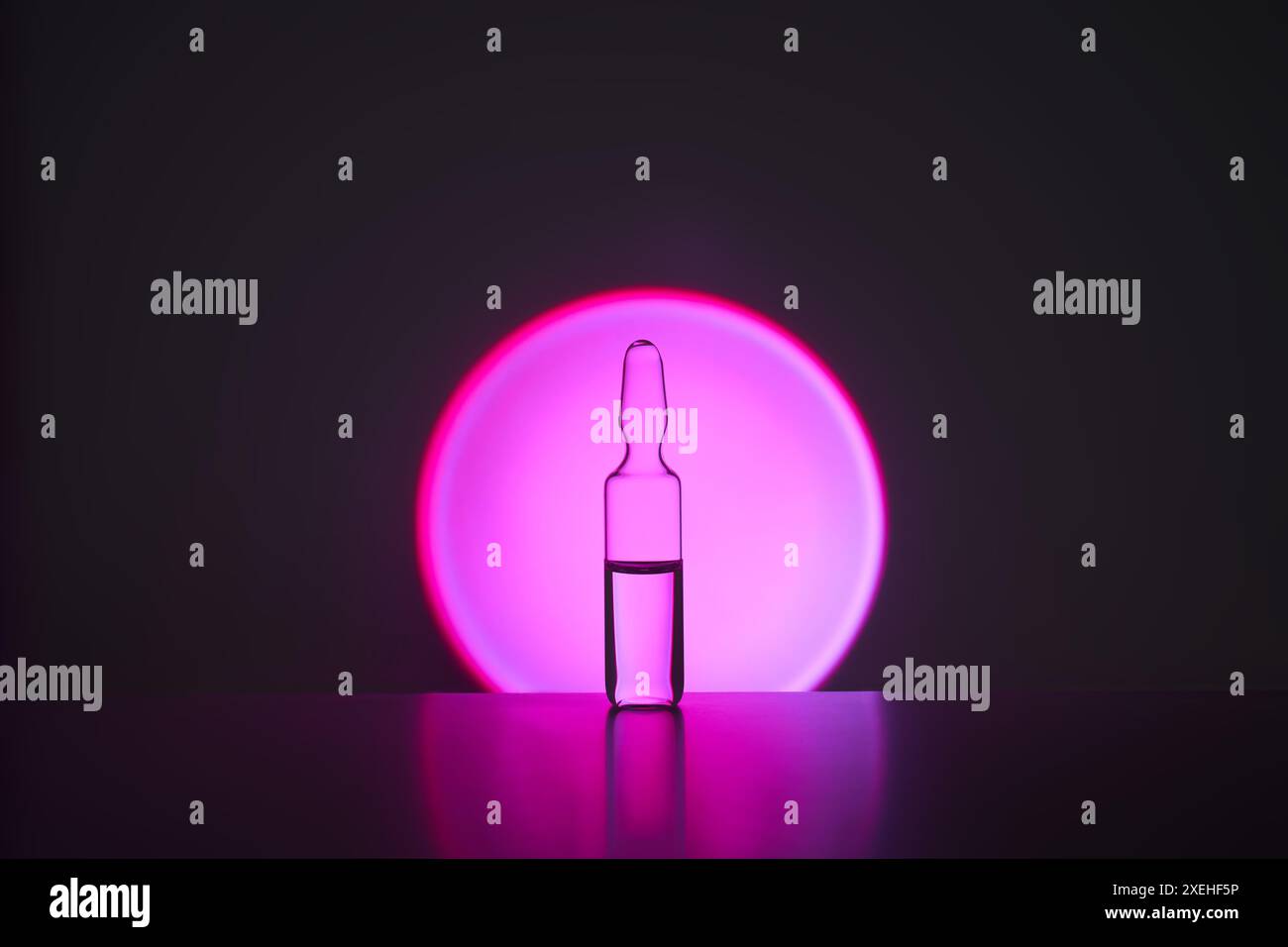 Several ampoules for injection with medicines on a lilac background ...