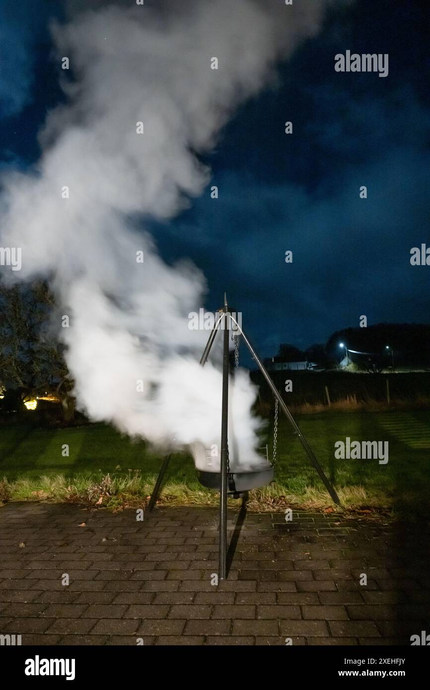 Smoke rising from a hanging fire pit Stock Photo - Alamy