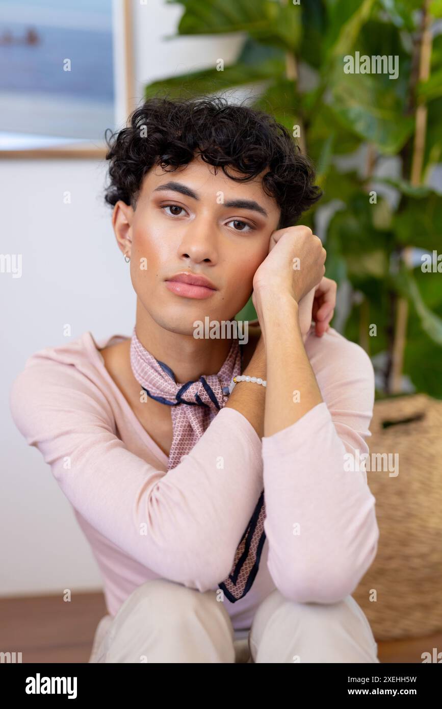 Relaxing at home, transgender transgender woman sitting and looking ...