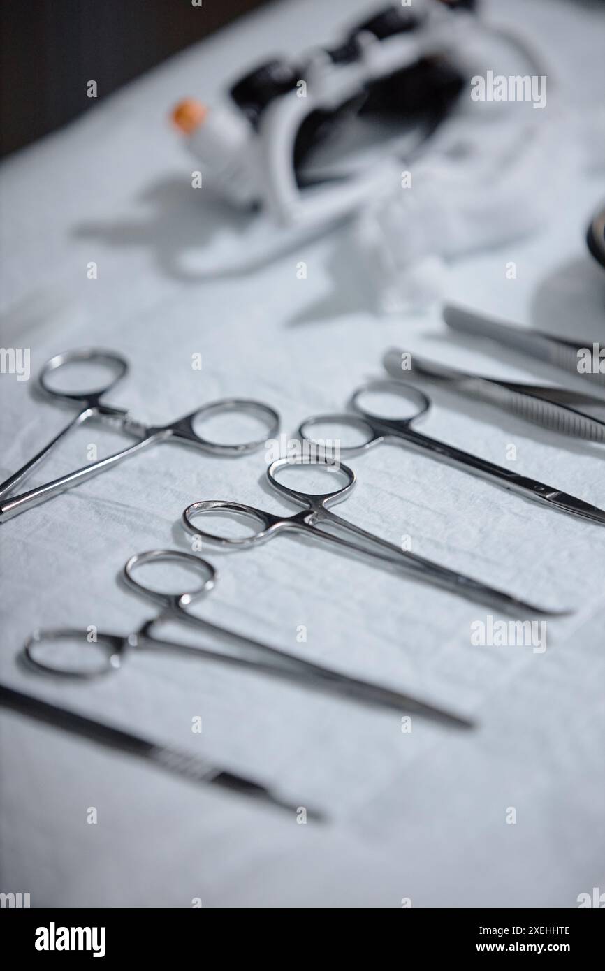 Vertical background image of various metal forceps and surgical tools ...