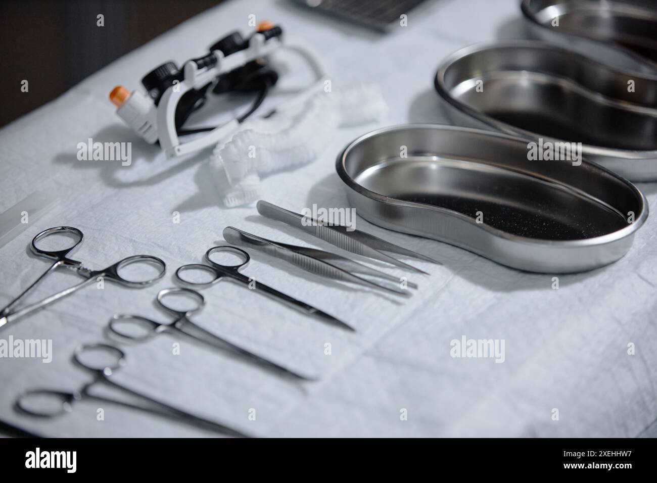 Background image of metal surgical tools laid out on table in operating ...