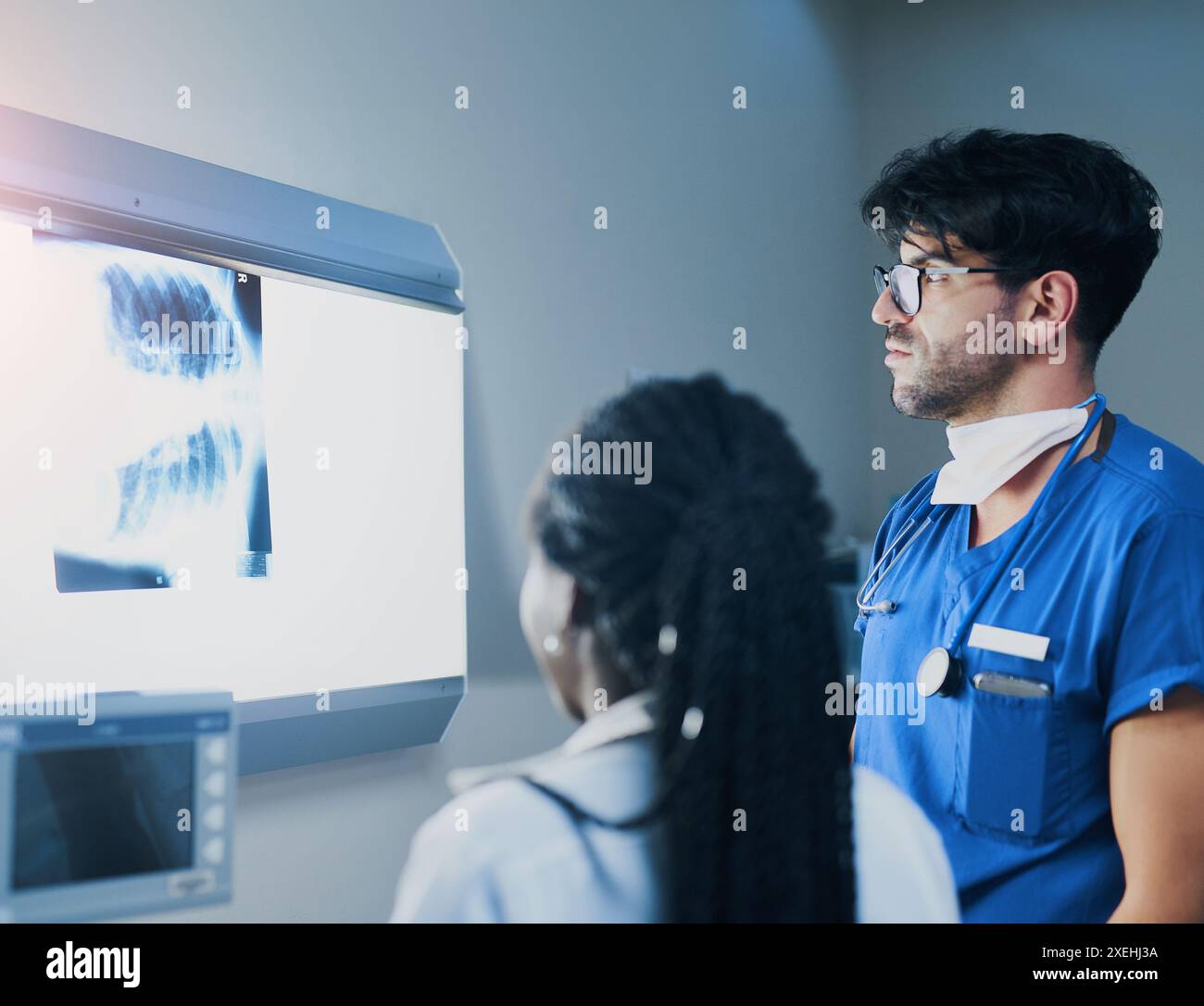 Hospital, doctor and x ray examination with nurse, patient and people ...