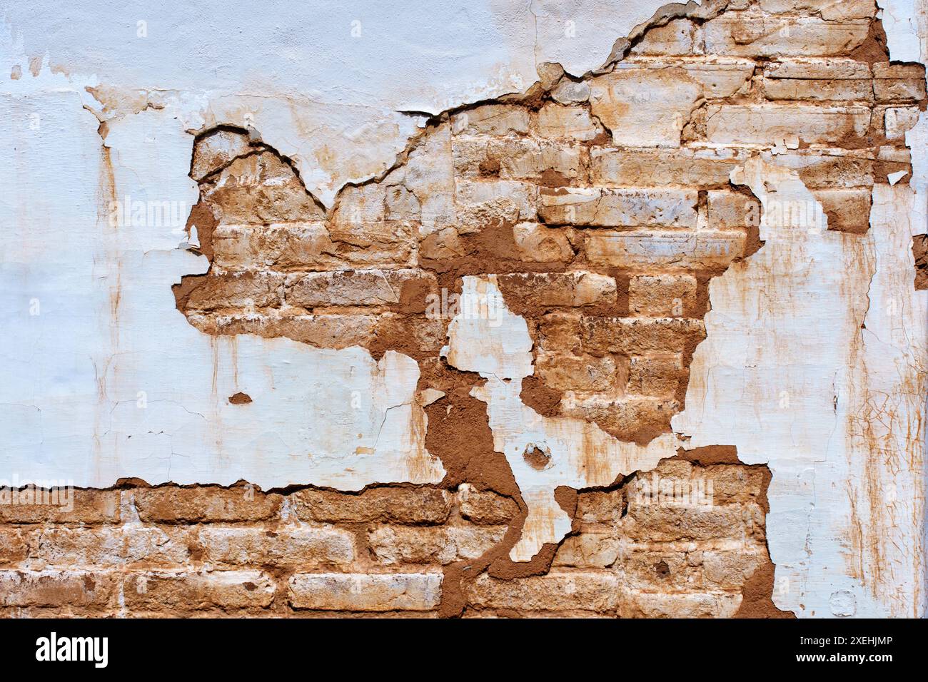Close-up of a deteriorating wall showing layers of old paint peeling ...
