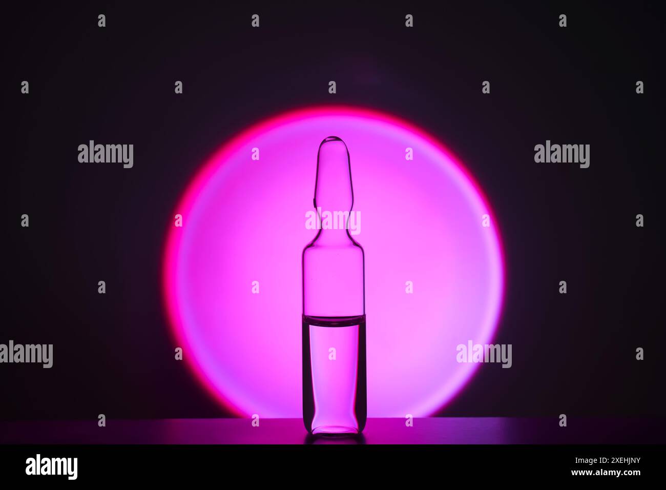 Several ampoules for injection with medicines on a lilac background ...