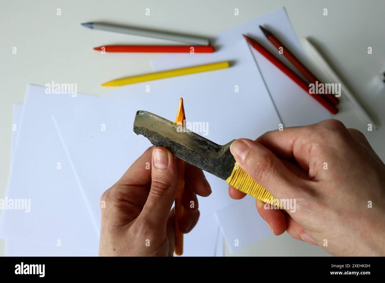 Photo of process of sharpening colored pencils with a clerical knife ...