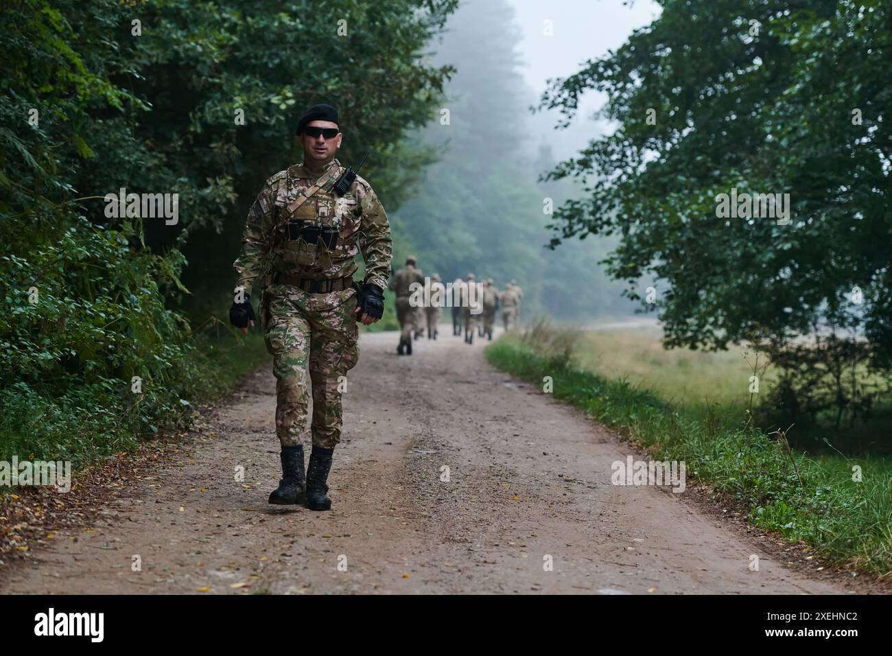A group of elite soldiers leads captives through a military camp ...