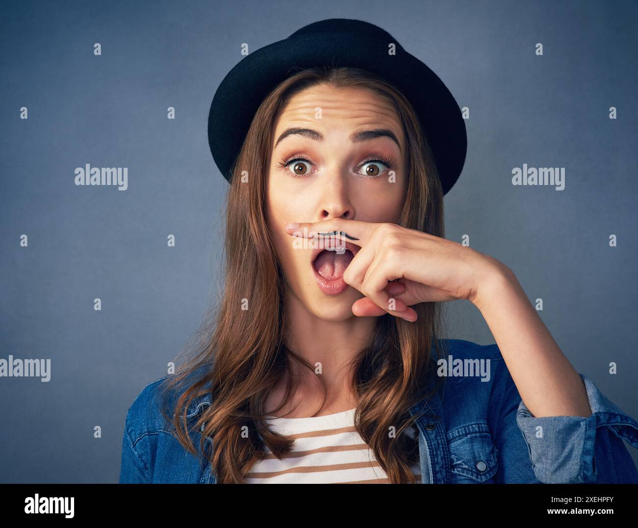 Girl, finger and mustache in studio with portrait for quirky behavior ...