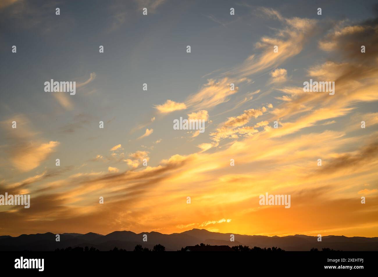 Colourful sunset sky. Full frame view of wispy colourful clouds up in ...