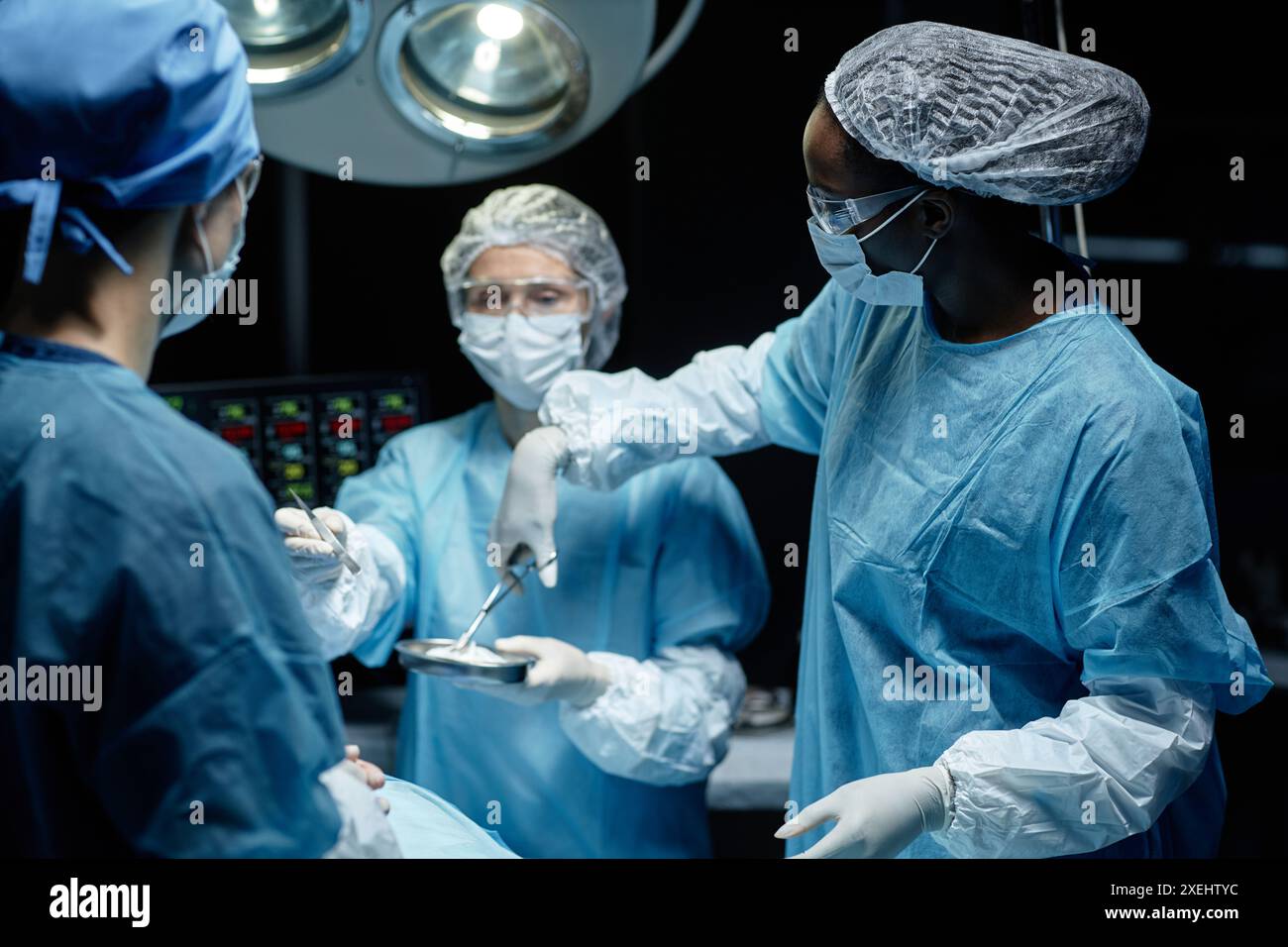 Side view portrait of African American female surgeon working with ...