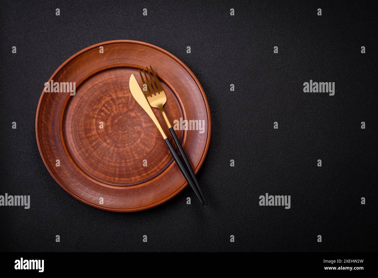 Bumpy empty ceramic plate on a textured concrete background Stock Photo ...
