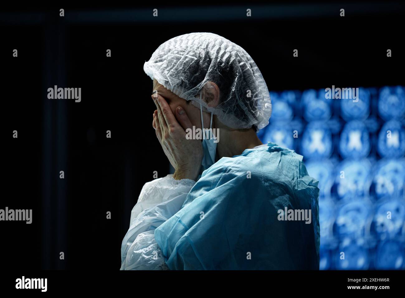 Side view portrait of exhausted female surgeon rubbing eyes after long ...