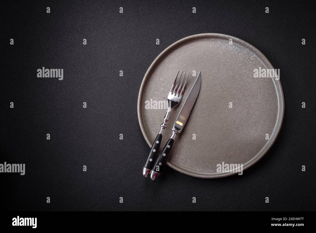 Bumpy empty ceramic plate on a textured concrete background Stock Photo ...