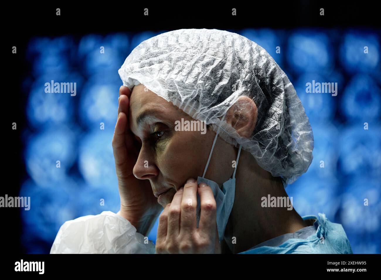 Side view portrait of mature woman as tired female surgeon taking break ...