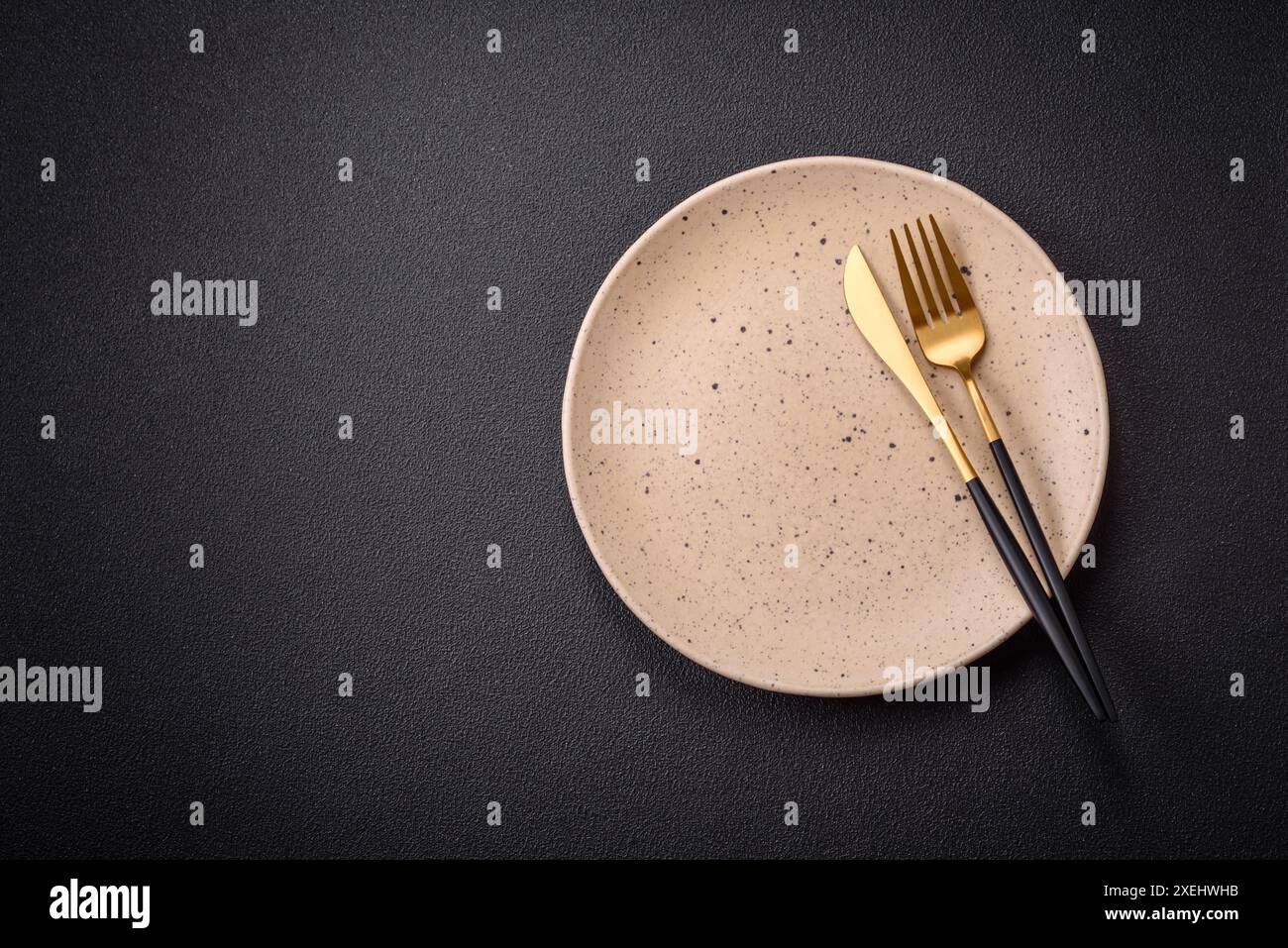Bumpy empty ceramic plate on a textured concrete background Stock Photo ...