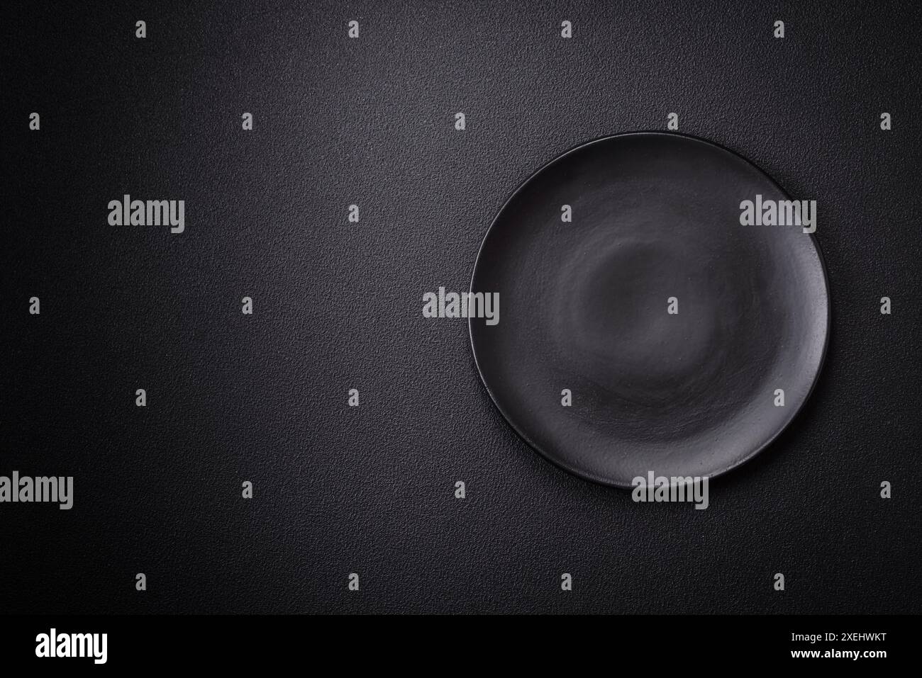 Bumpy empty ceramic plate on a textured concrete background Stock Photo ...