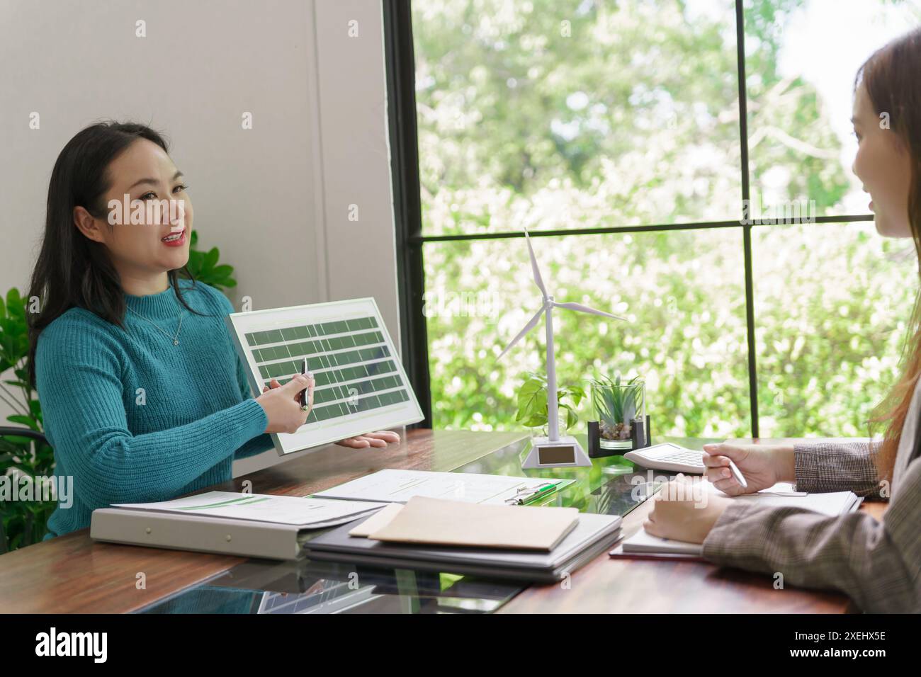 Solar panels green energy Business people working in green eco friendly office business meeting ...