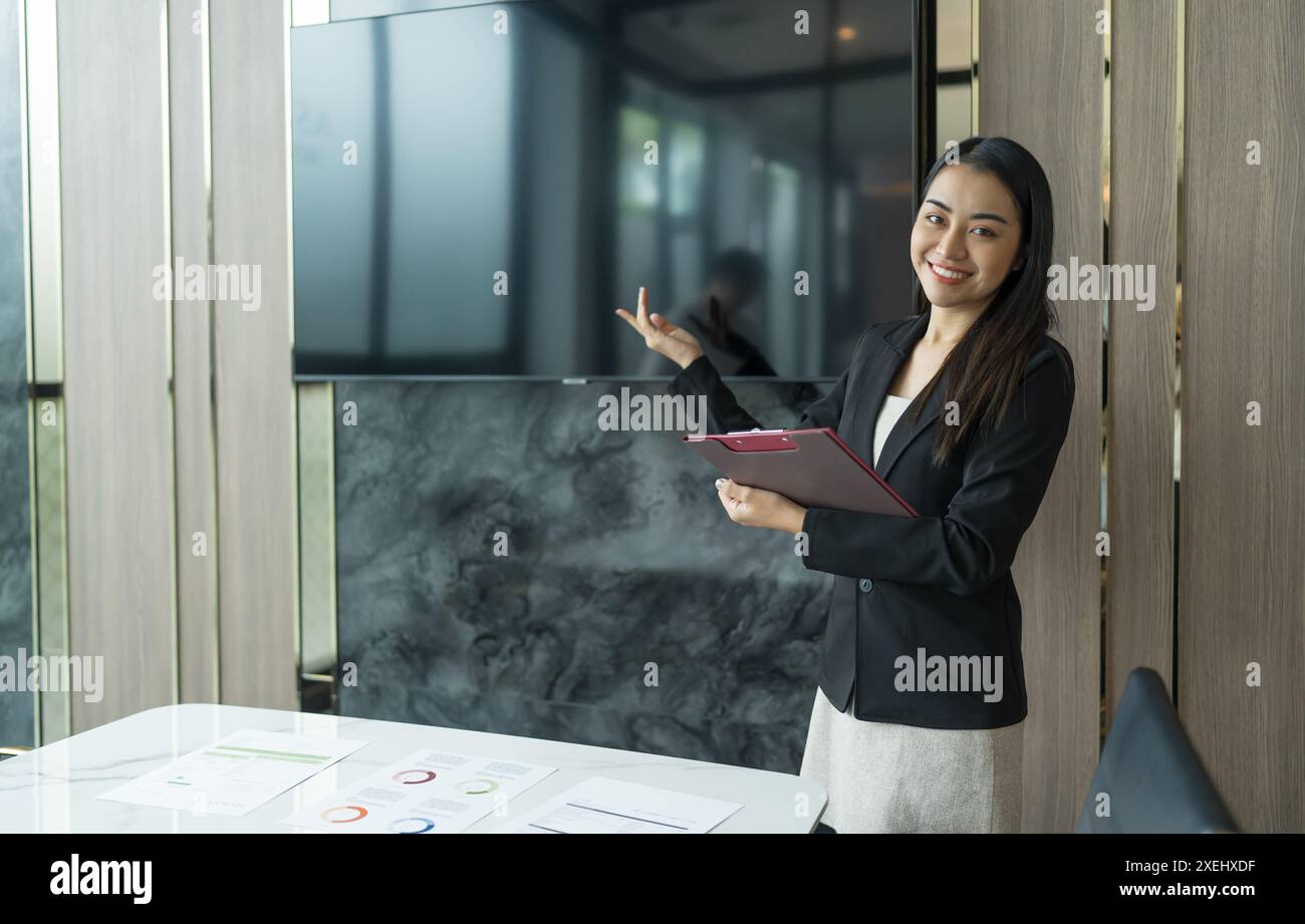 BeautifulÂ Asian Business Woman in black suit pointingÂ to present ...