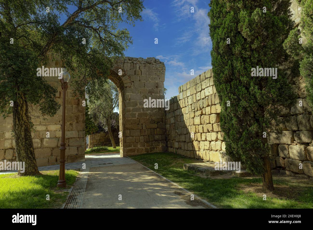 View of the ancient Roman walls in Merida, Spain, surrounded by tall ...