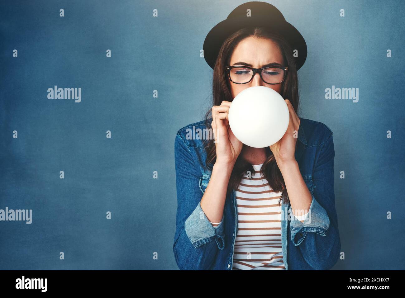 Studio, air and inflating balloon with woman for celebration, party and ...