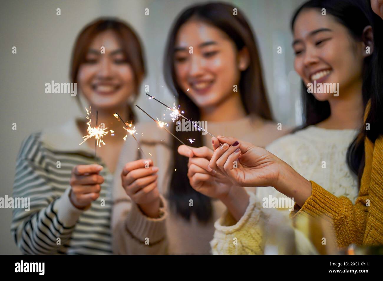 Cheerful friends enjoying home Birthday holiday party. Asian Friends ...